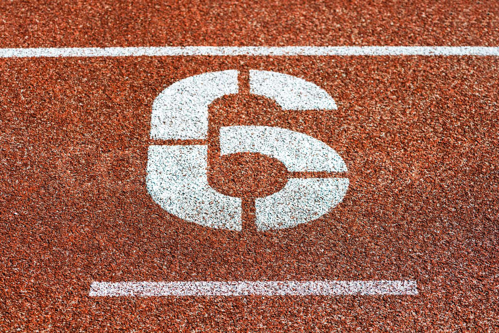 Start number six at cinder track of track and field running track ...