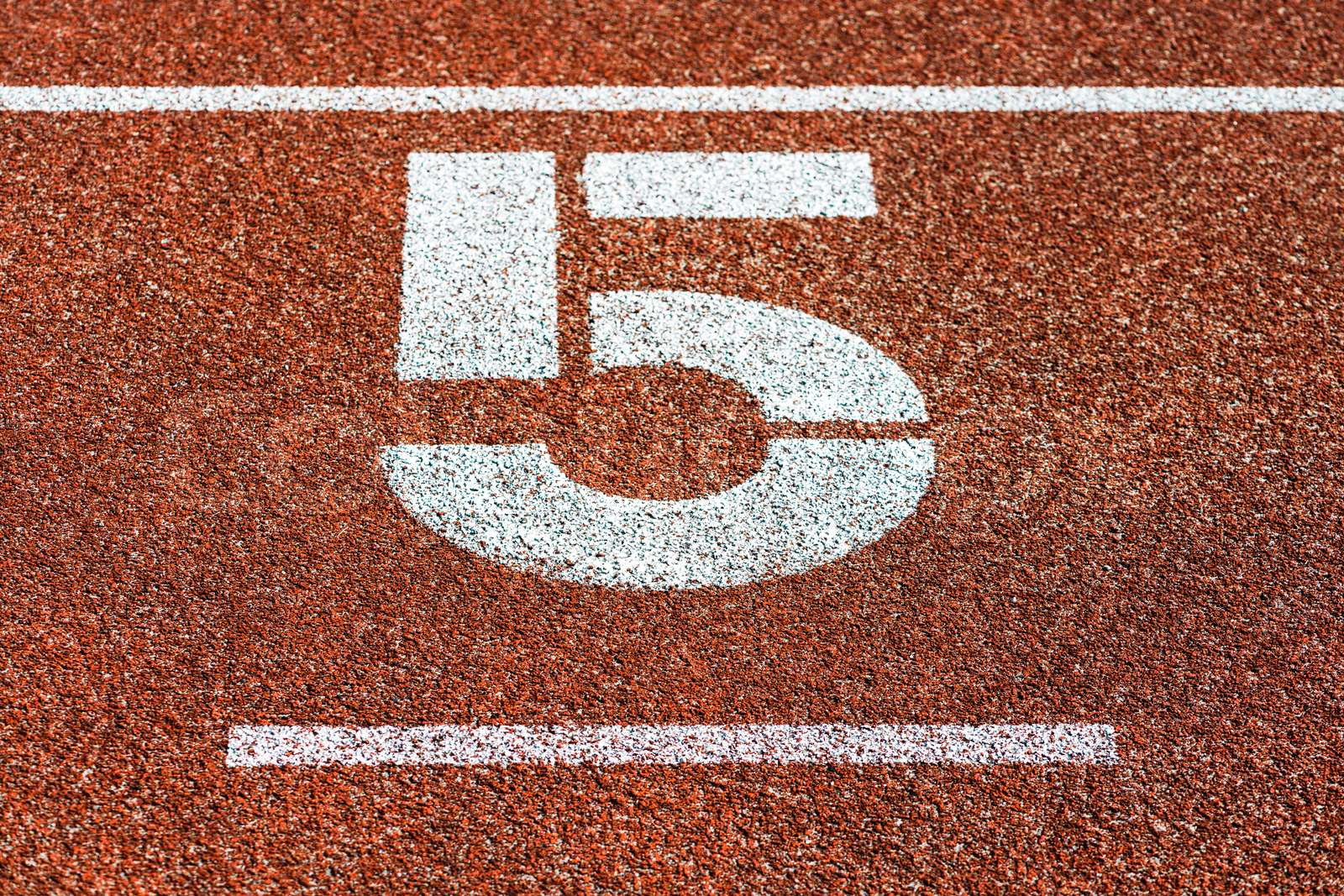 Start number five at cinder track of track and field running track ...