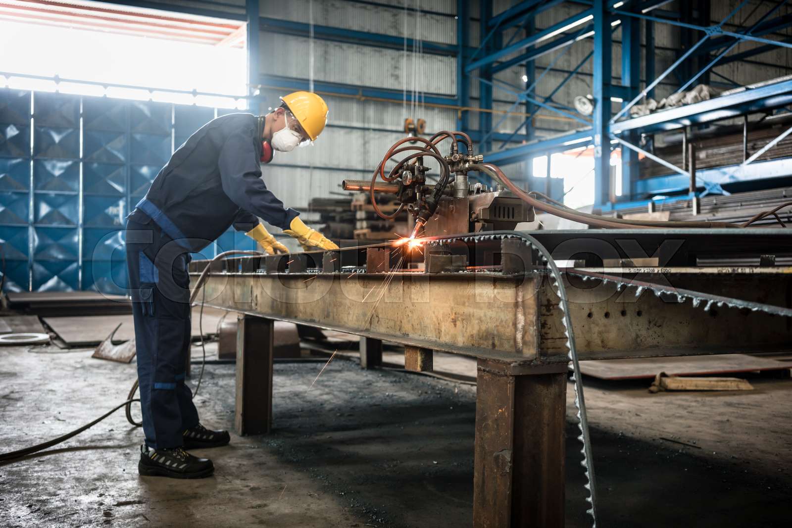 Asian worker using CNC plasma cutter | Stock image | Colourbox