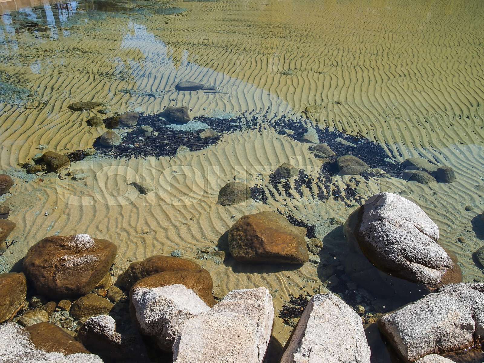 rock in clear lake water | Stock image | Colourbox