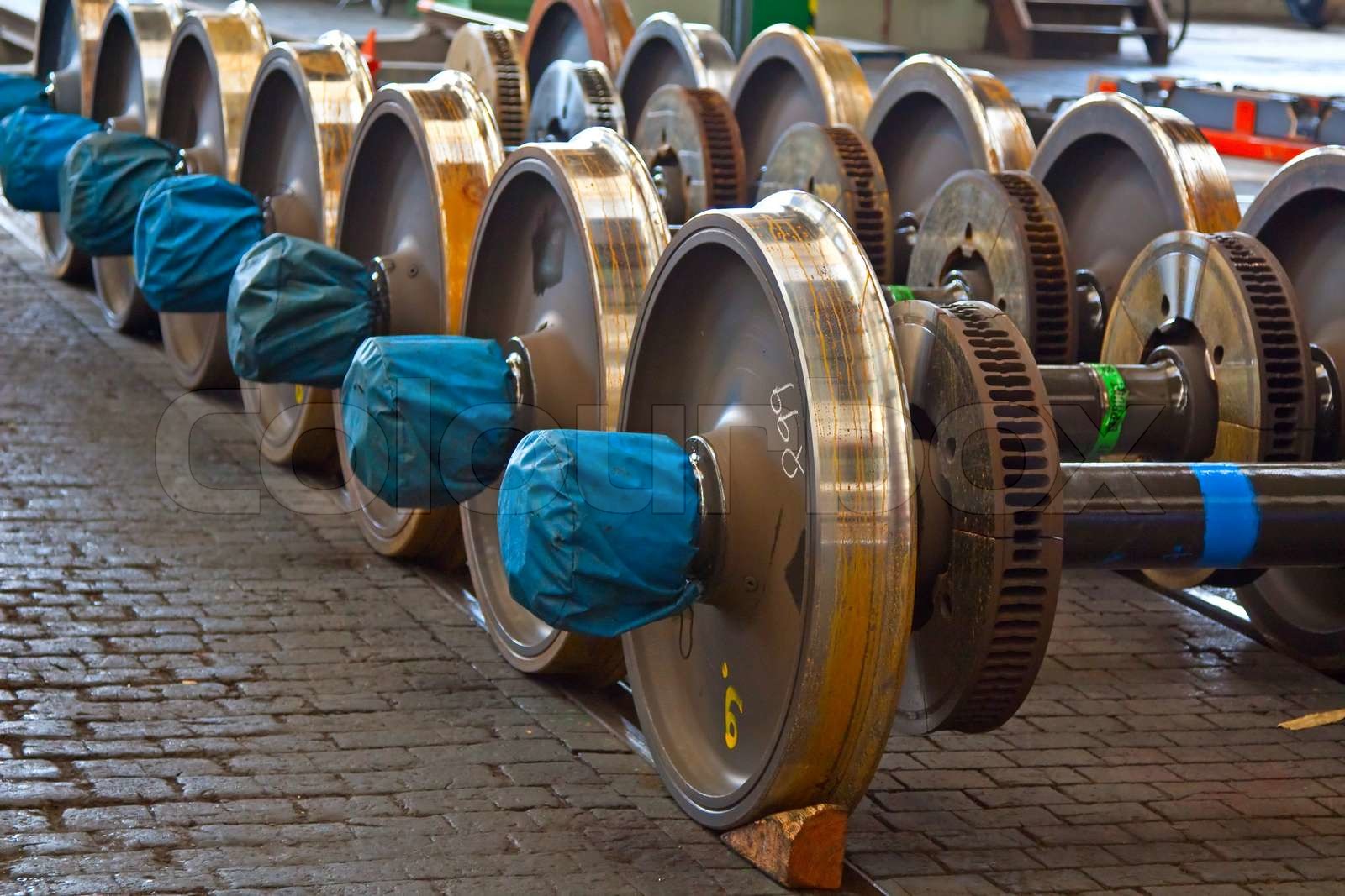 Spare railway wheels on the axle in a repair workshop | Stock image ...