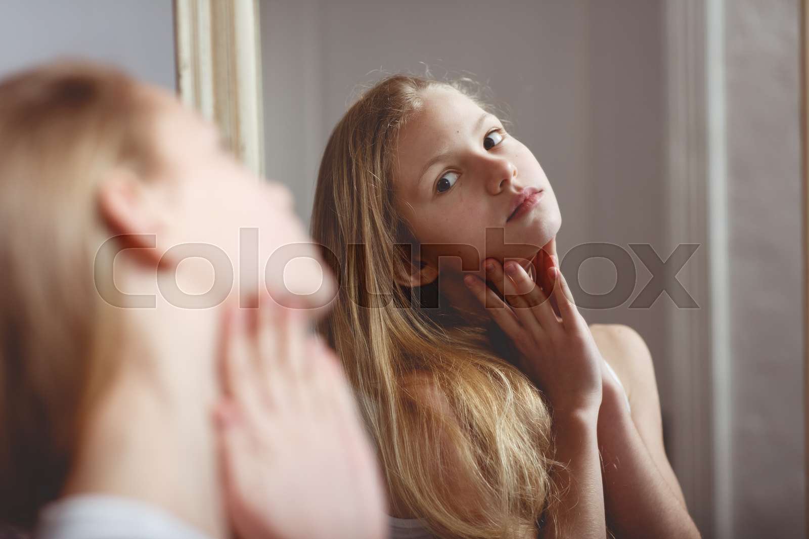 Reflection in mirror of teenage girl | Stock image | Colourbox