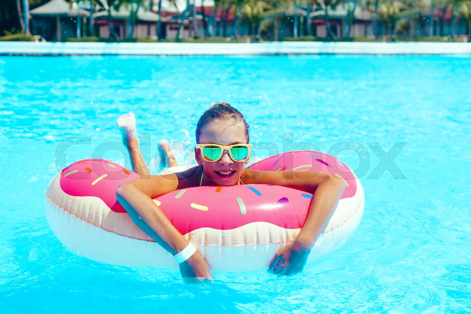 Tween girl in resort pool | Stock image | Colourbox