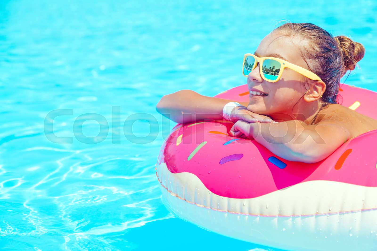 Tween girl in resort pool | Stock image | Colourbox