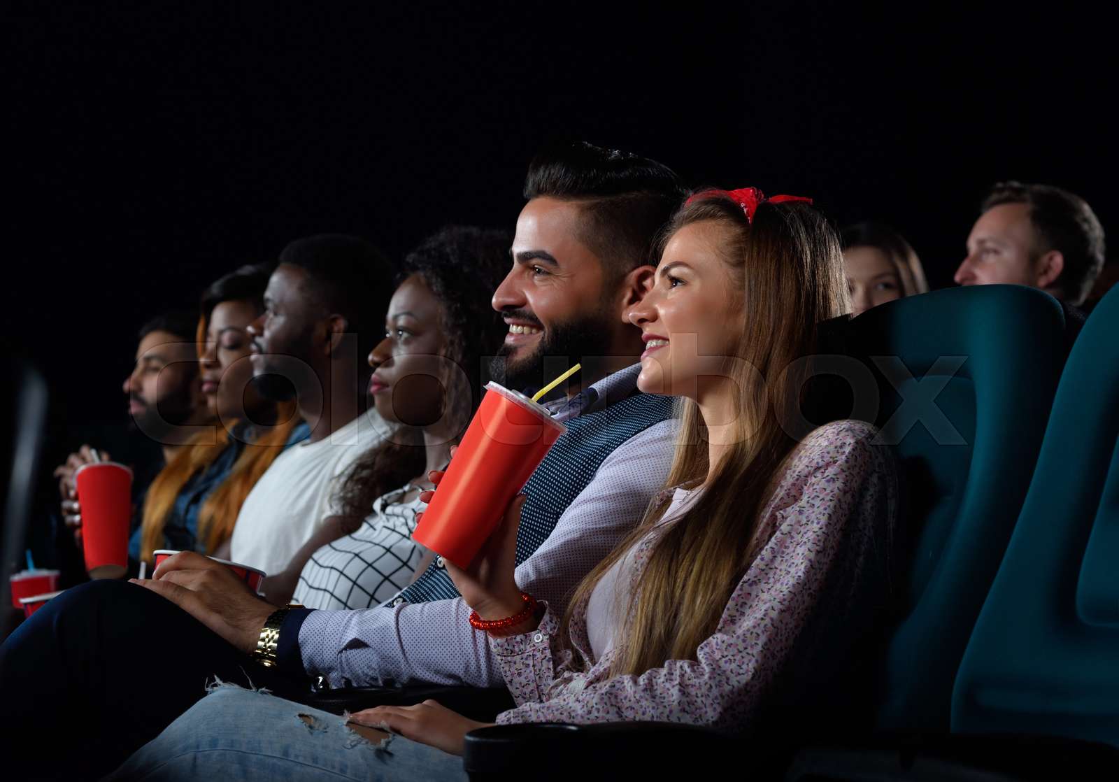 Group of friends watching movies at the local cinema | Stock image ...