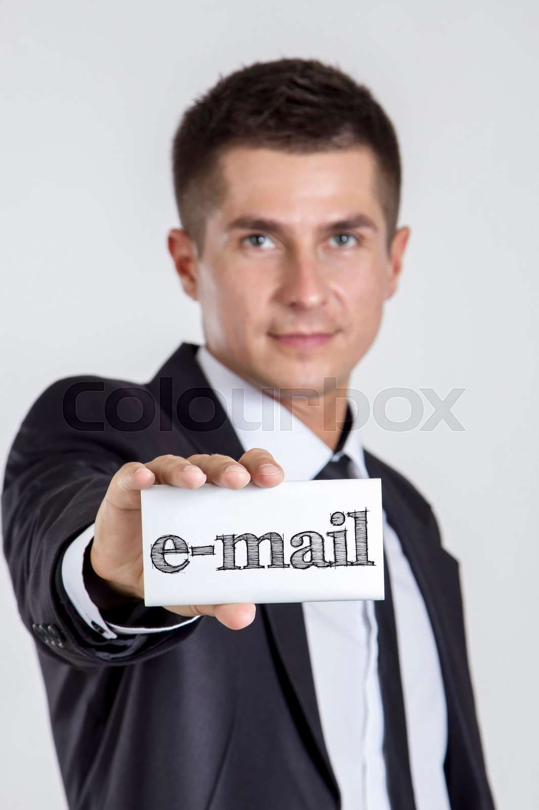 e-mail - Young businessman holding a white card with text | Stock image ...