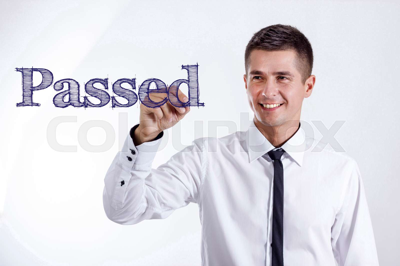 Passed - Young smiling businessman writing on transparent surface ...