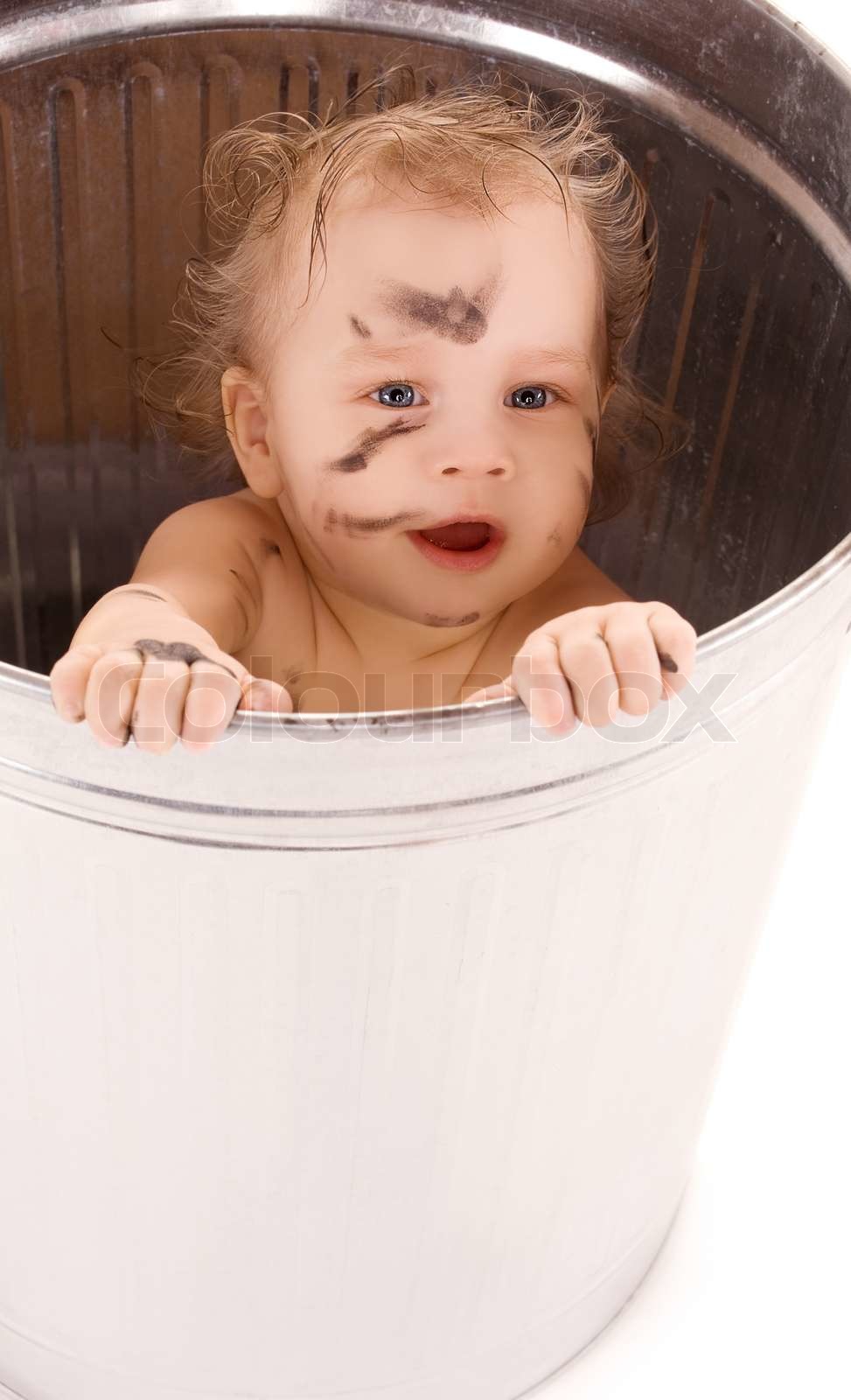 picture of adorable baby in trash can | Stock image | Colourbox