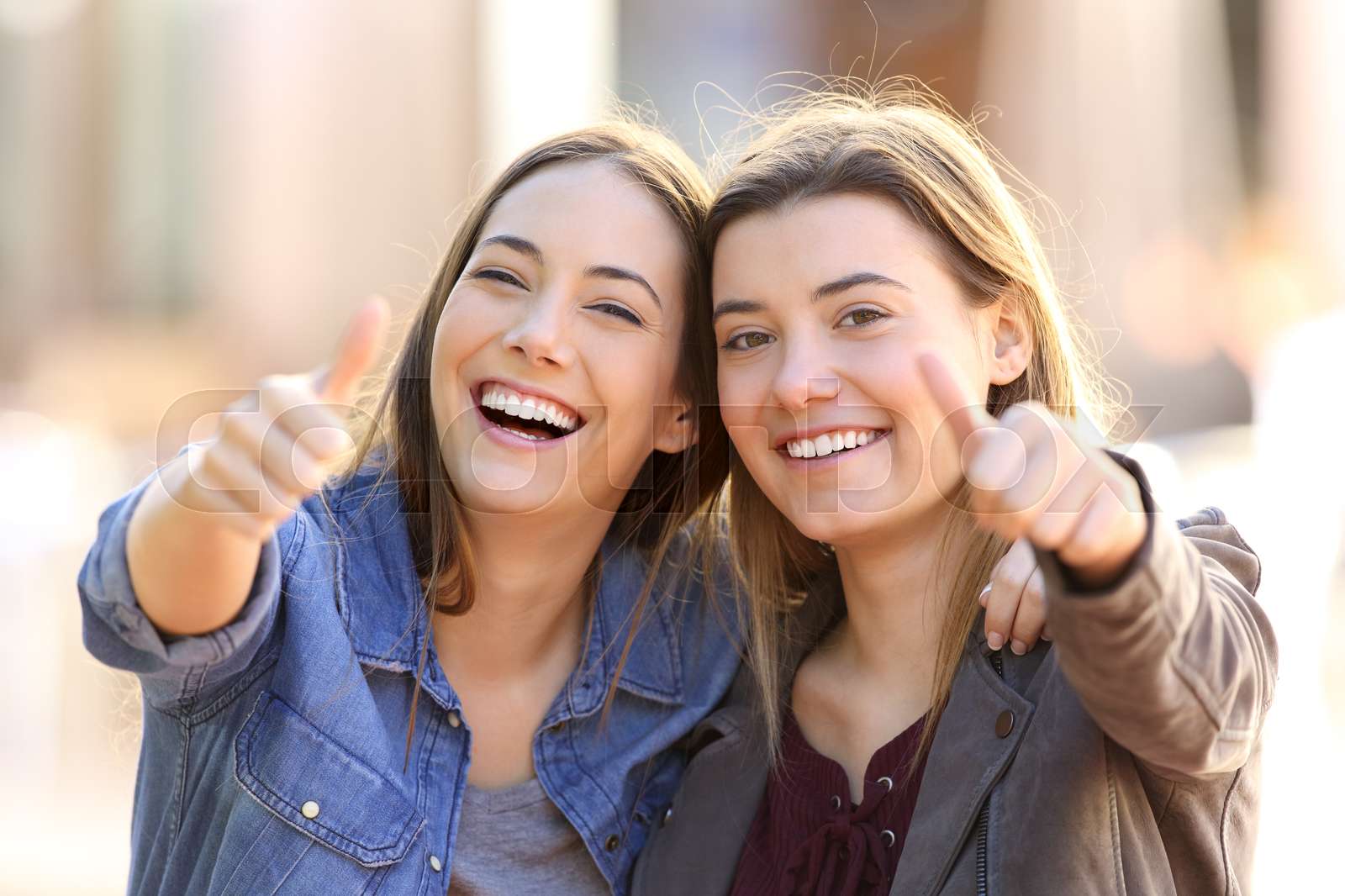 Two funny friends with thumbs up | Stock image | Colourbox