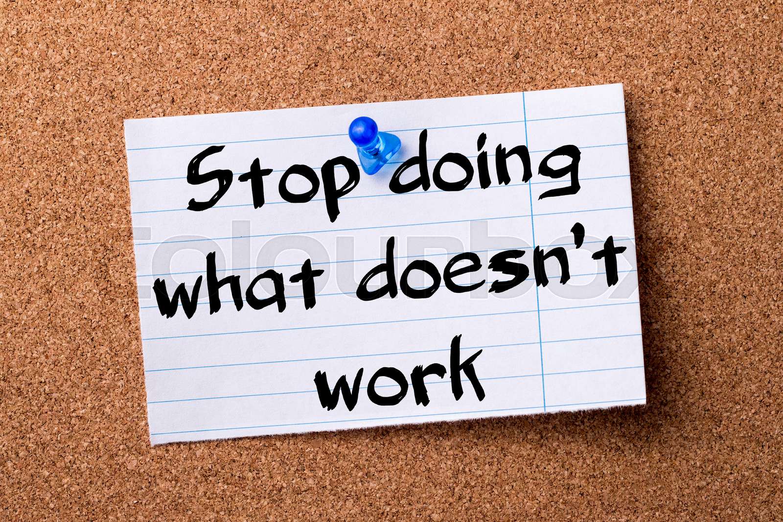 Stop doing what doesn’t work - teared note paper pinned on bulletin ...