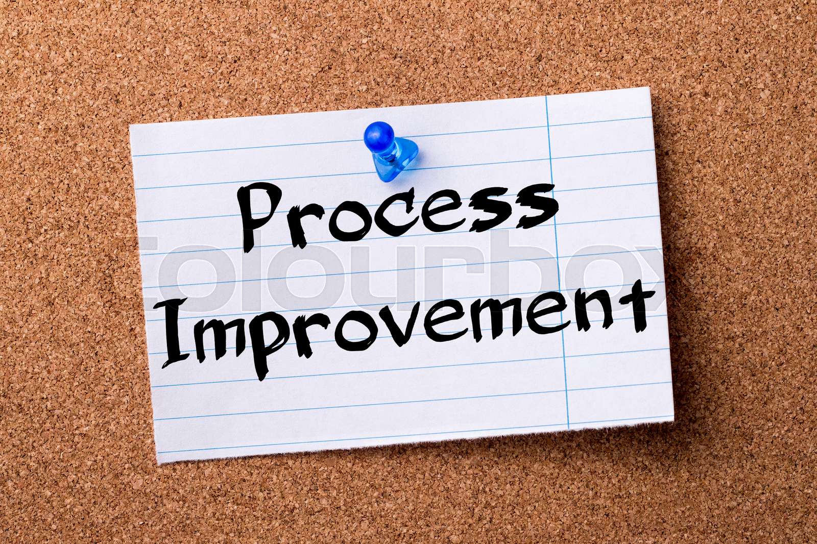 Process Improvement - teared note paper pinned on bulletin board ...