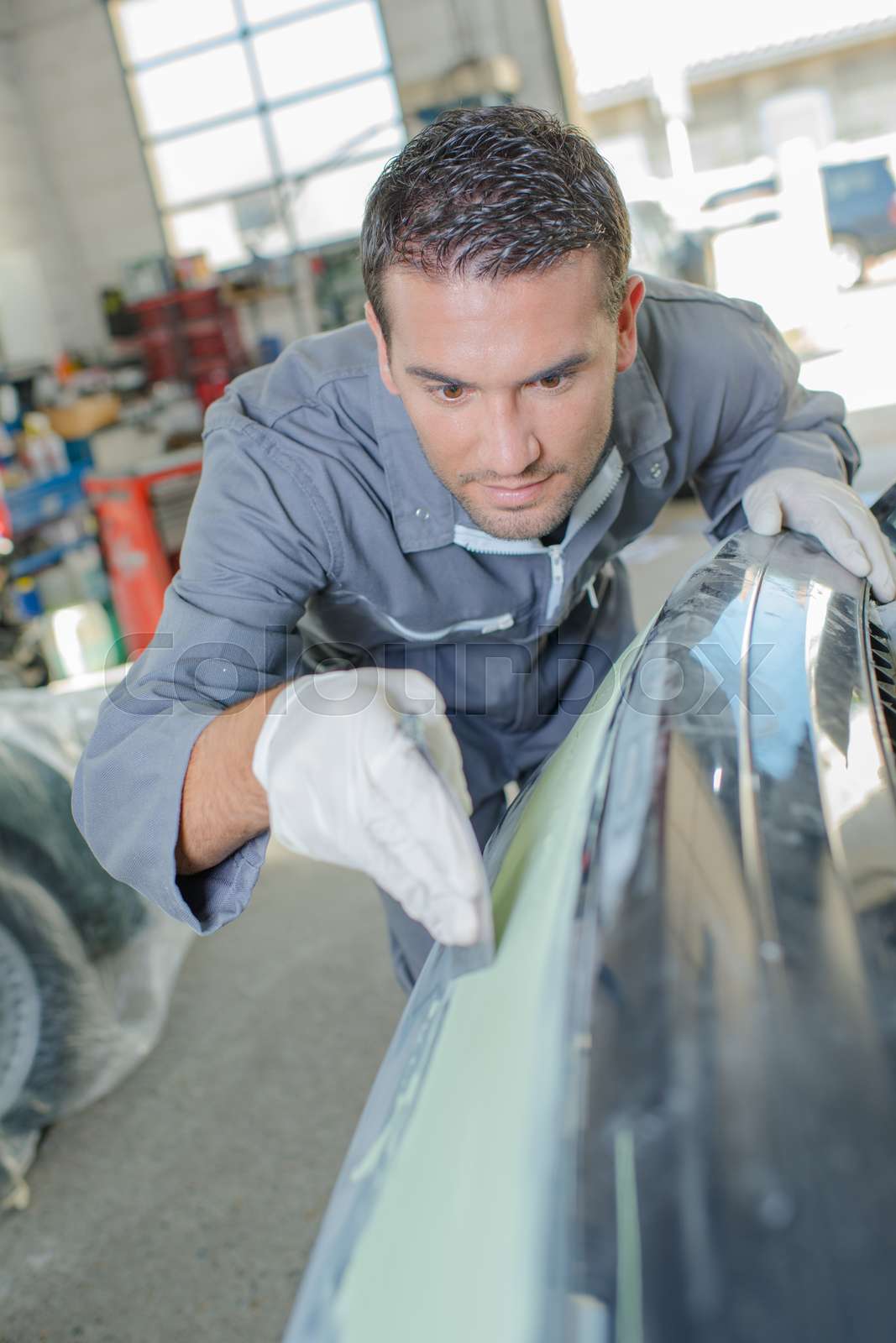 man working a car bumper | Stock image | Colourbox