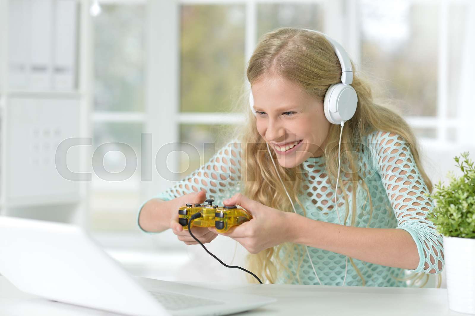 Teenage girl playing a computer game | Stock image | Colourbox