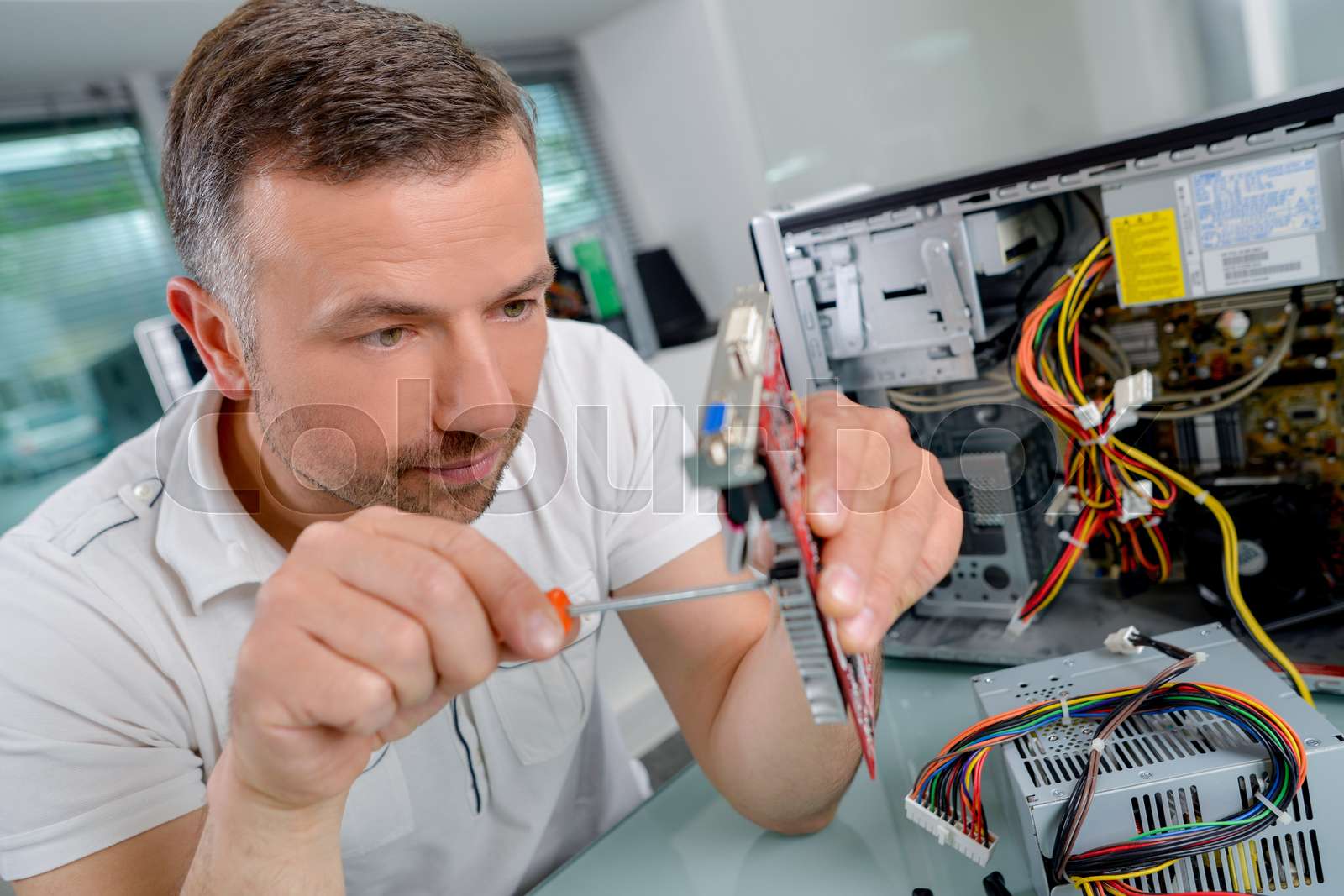 Man working on computer component | Stock image | Colourbox