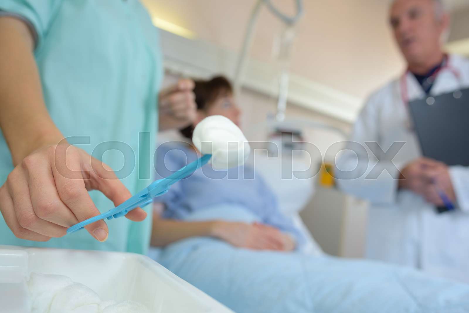 Nurse holding cotton wool in plastic utensil | Stock image | Colourbox