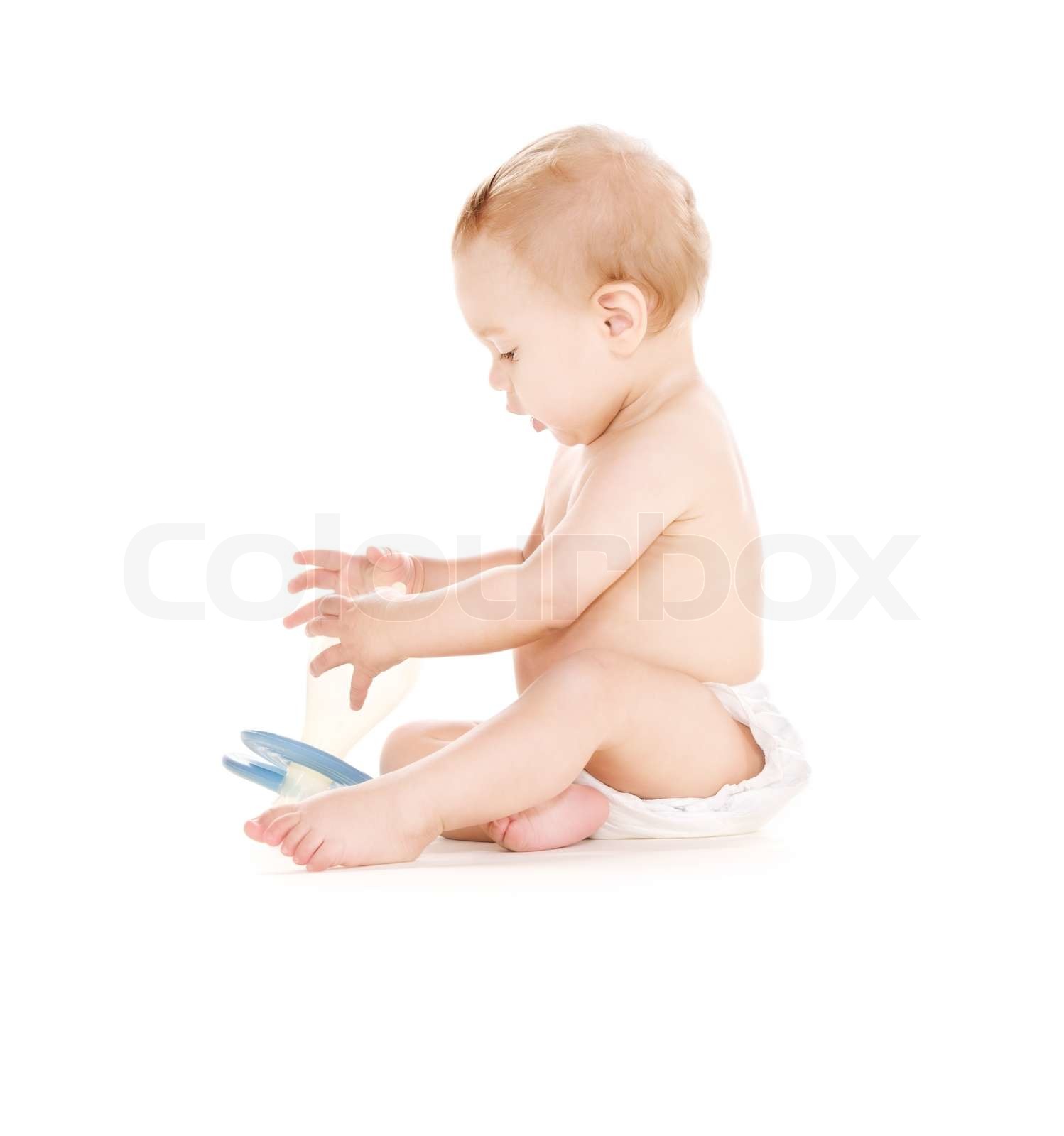 billede af baby dreng med stor sut over hvide | Stock foto | Colourbox