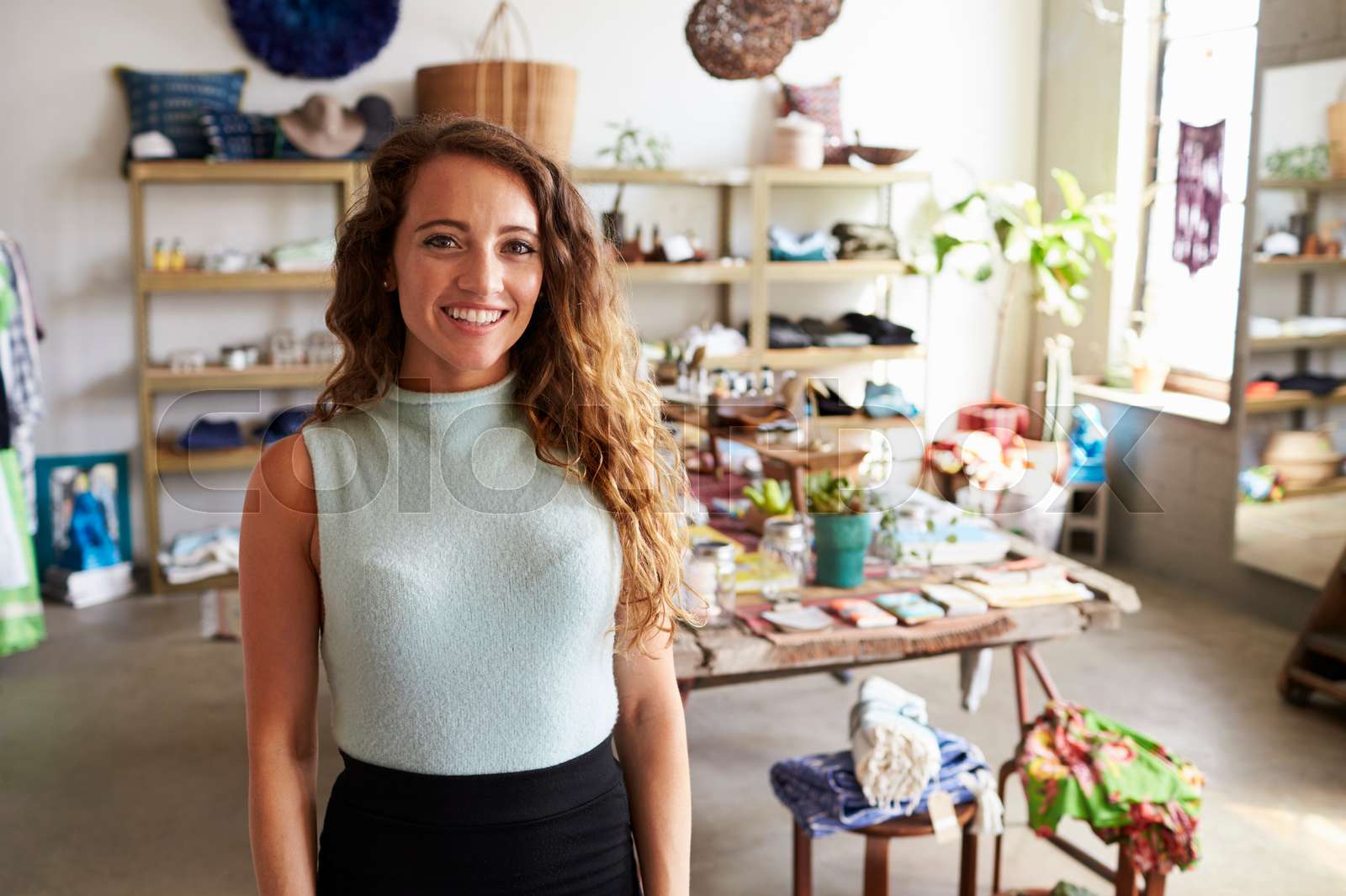 Female sales assistant standing in clothes shop, portrait | Stock image ...