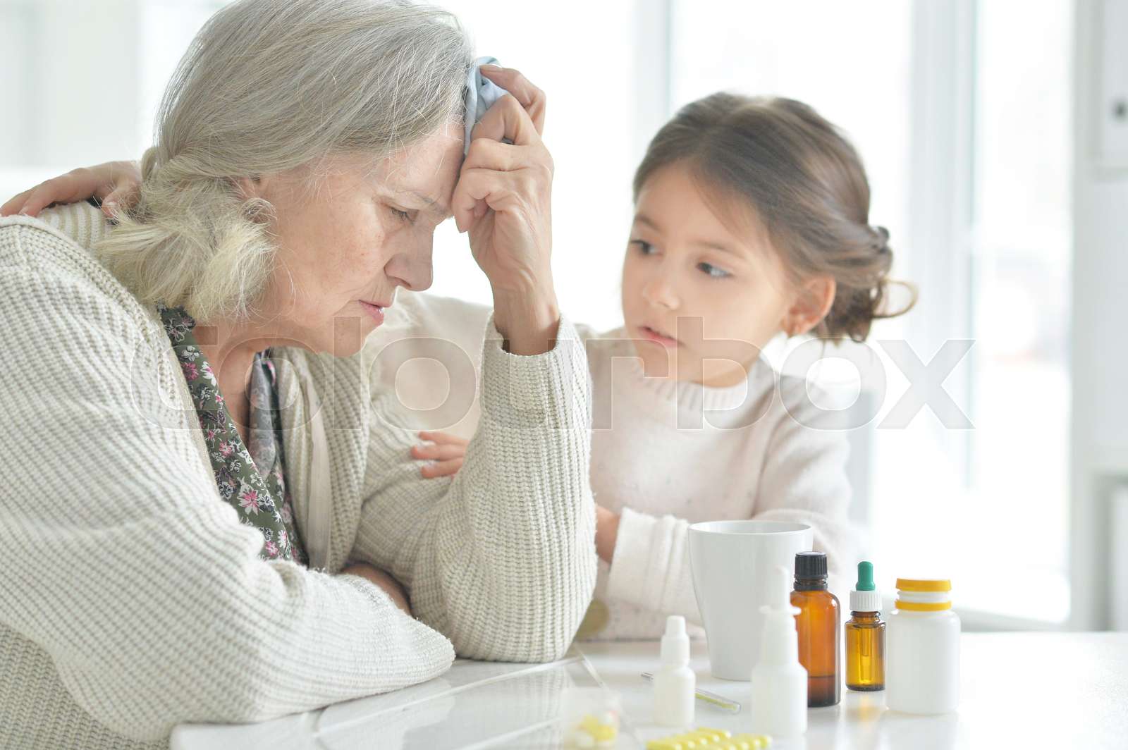 Granddaughter takes care of a sick grandmother | Stock image | Colourbox