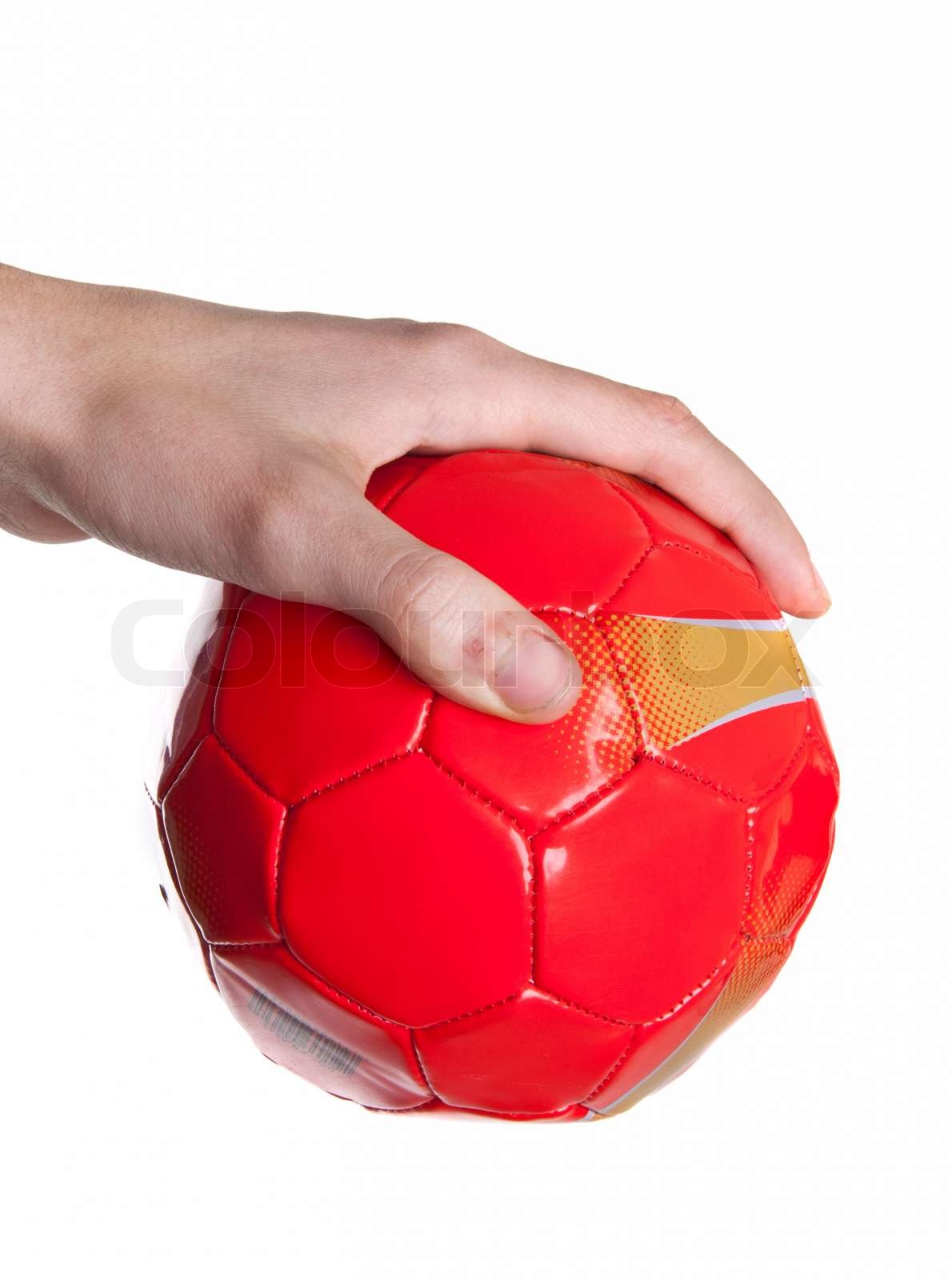 A hand hold a red ball isolated | Stock image | Colourbox