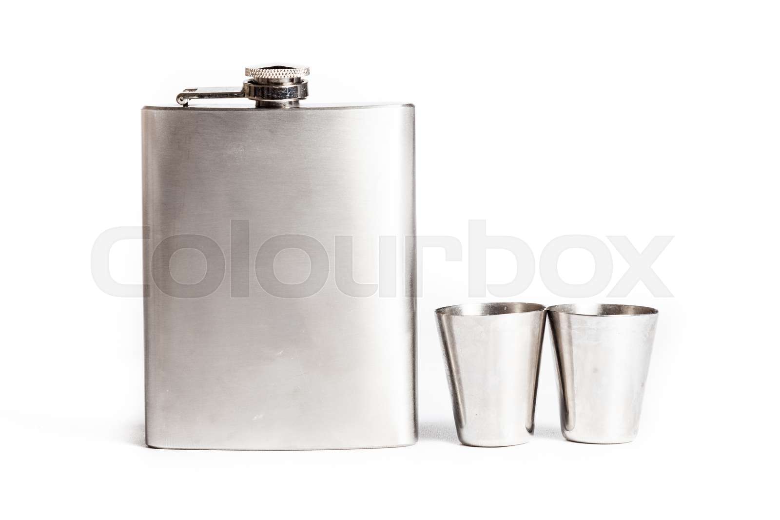 Hip flask and cups isolated on white | Stock image | Colourbox