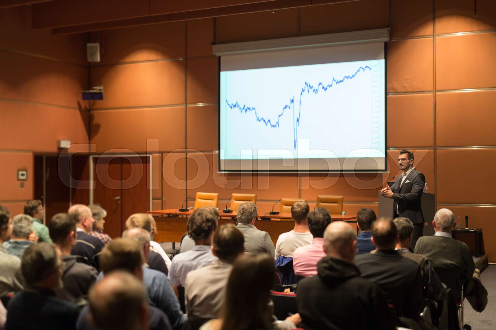 Business speaker giving a talk in conference hall. | Stock image ...