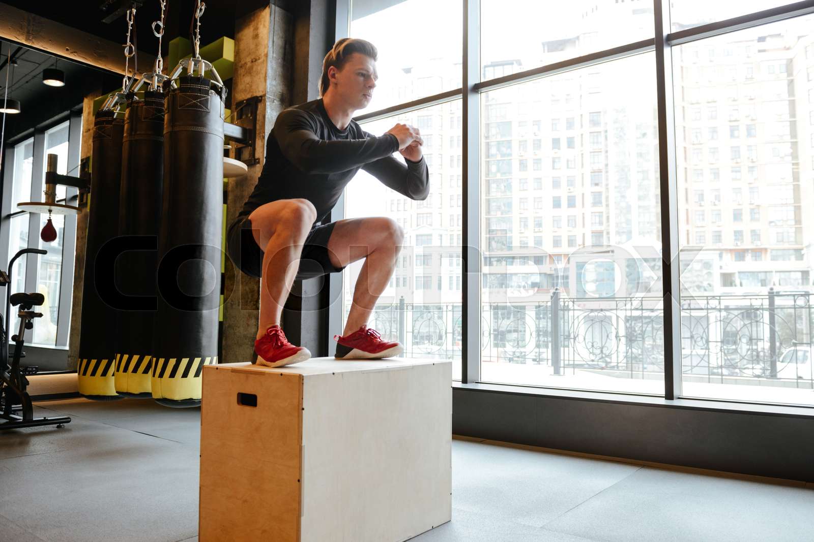 Side view of Athletic man jumping on box | Stock image | Colourbox