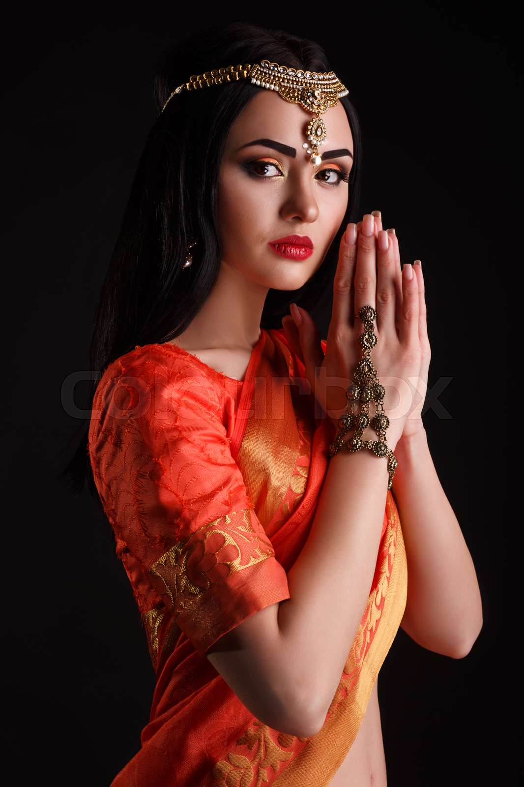 Beautiful young Indian girl in namaste pose. | Stock image | Colourbox