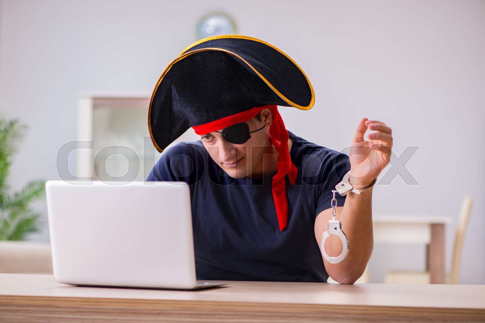 Digital security concept with pirate at computer | Stock image | Colourbox
