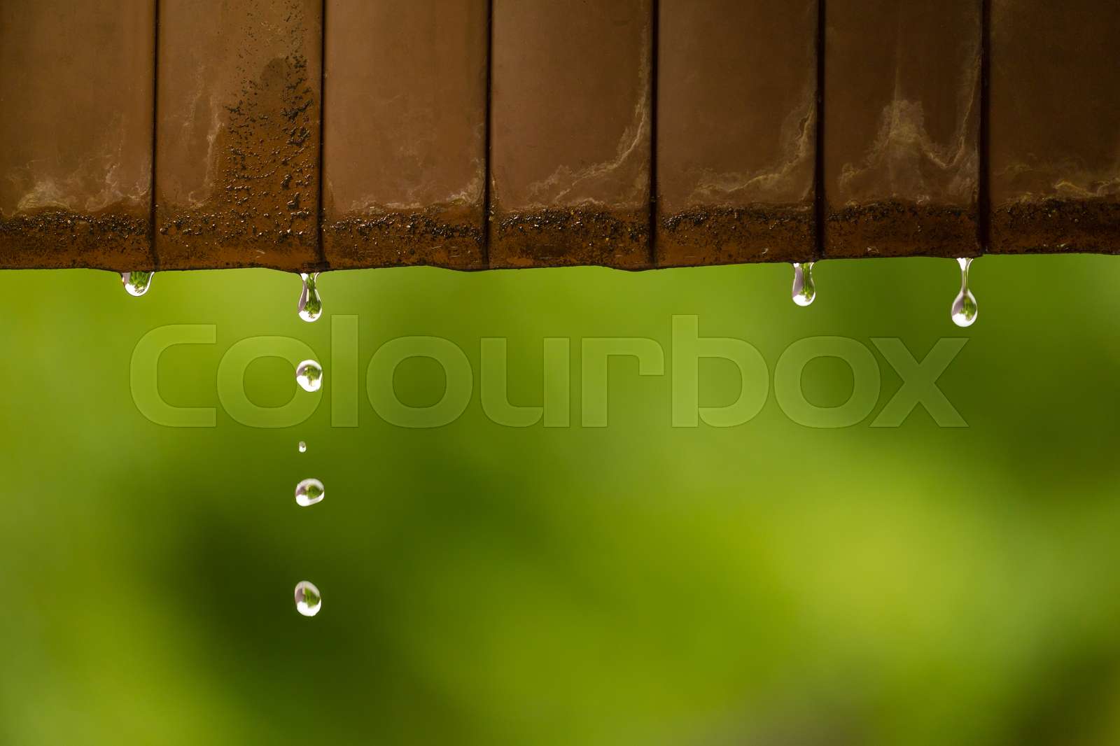 Rain water droplets coming down from rusted metal roof | Stock image ...