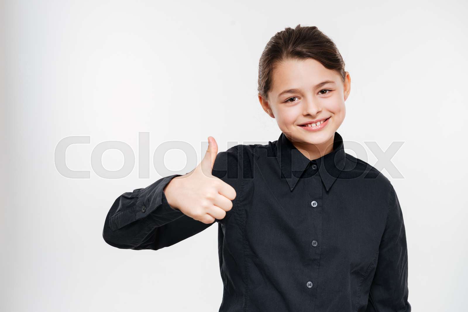 Smiling young girl make thumbs up gesture | Stock image | Colourbox