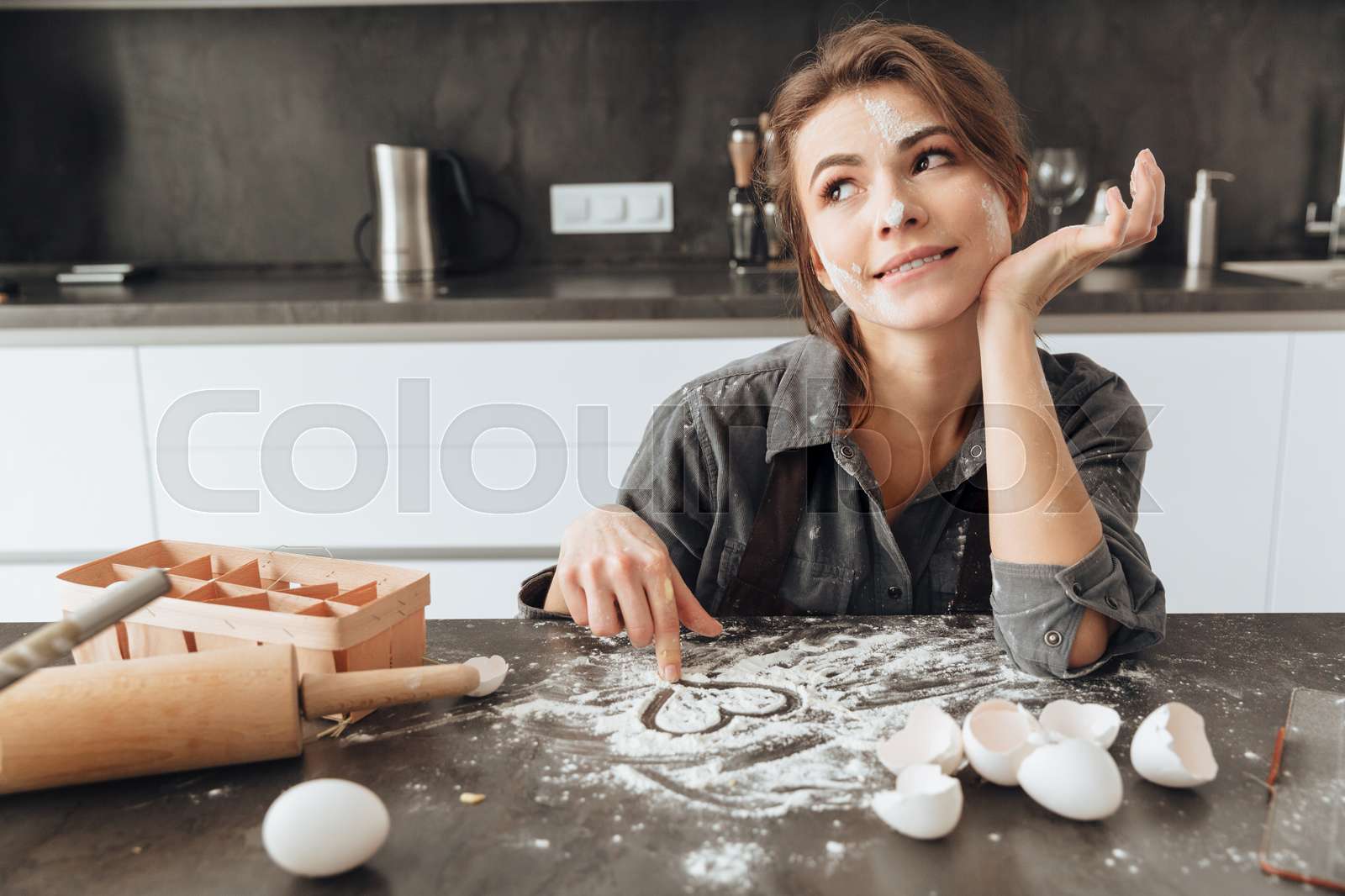 Incredible lady sitting in kitchen while cooking | Stock image | Colourbox