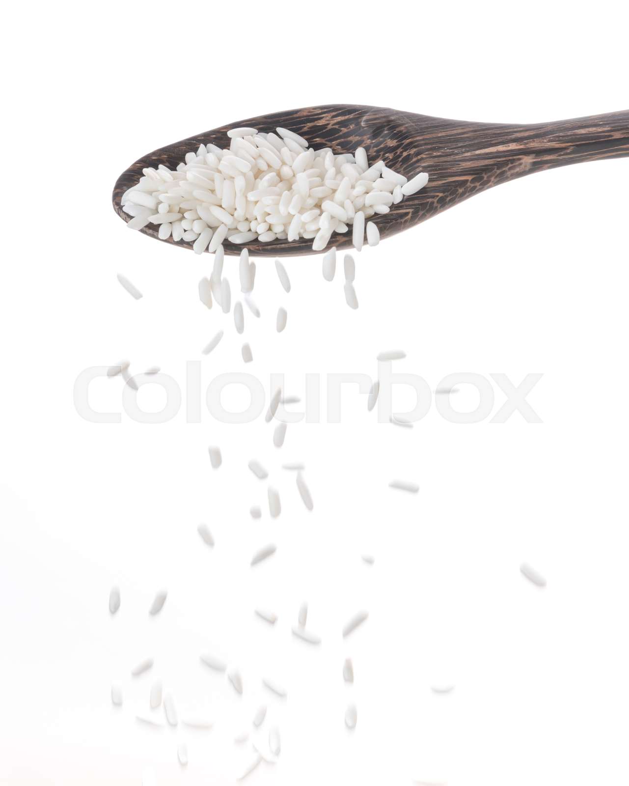 dropped rice grain down from a spoon isolated on white background ...
