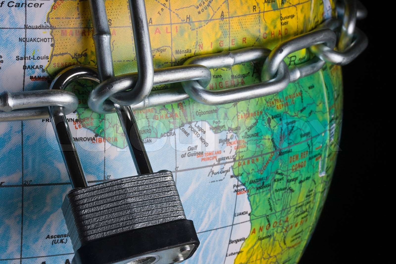 Metal lock and chain on a globe | Stock image | Colourbox