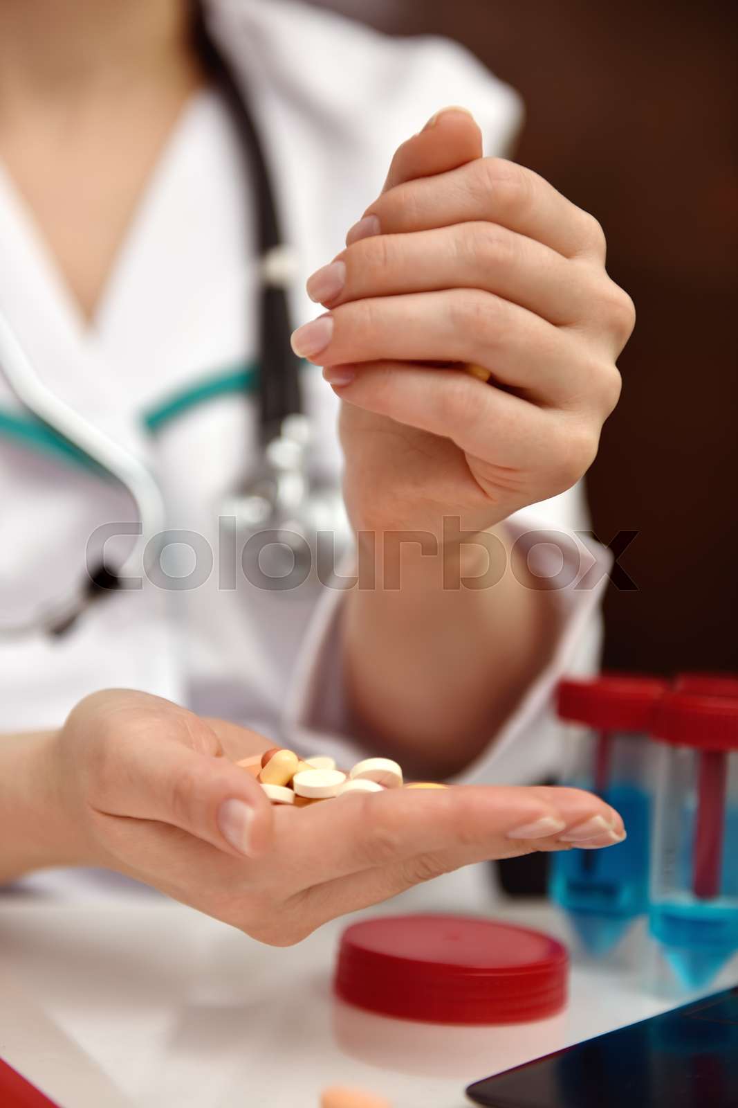 doctor holding pills | Stock image | Colourbox
