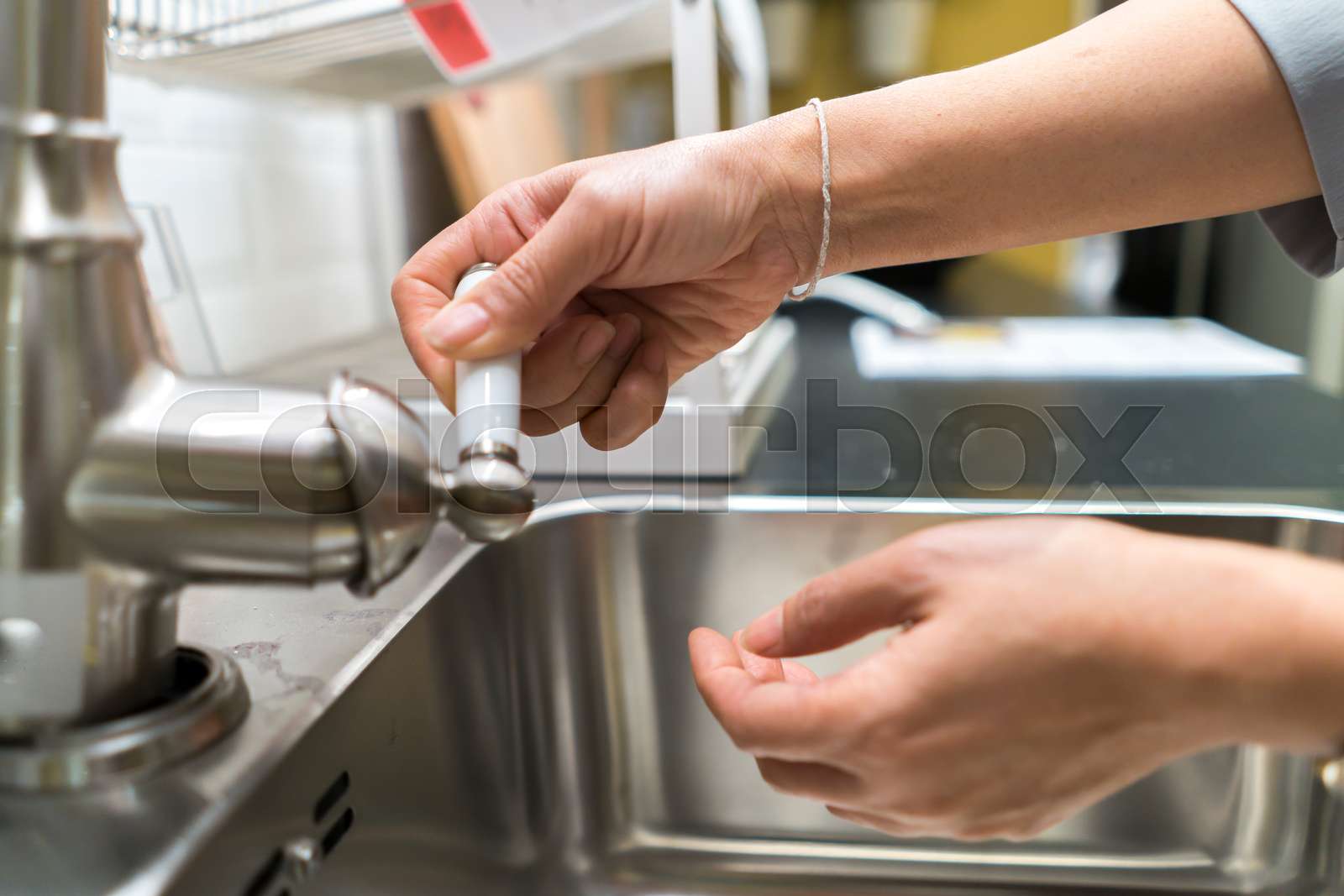 Woman hand opening the water tap | Stock image | Colourbox