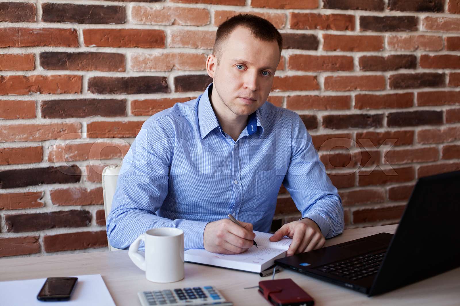 Man accountant working at his desk | Stock image | Colourbox