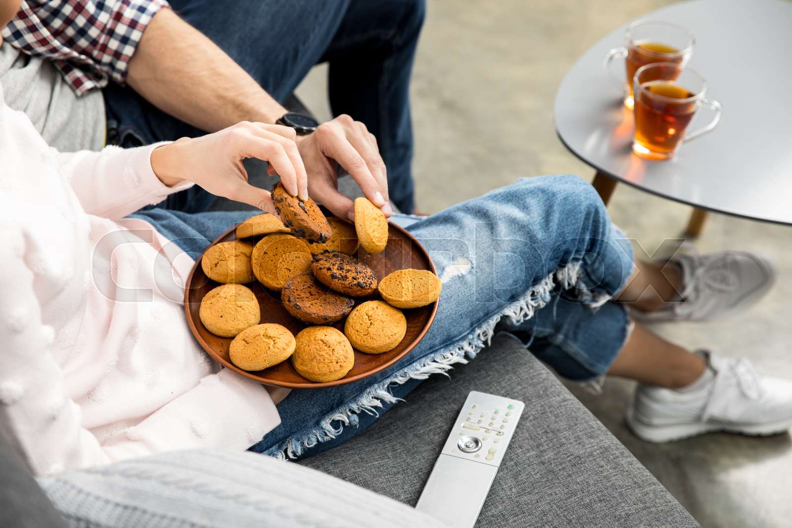 Couple drinking tea with biscuits | Stock image | Colourbox