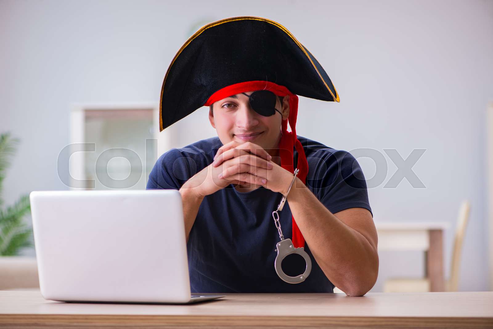 Digital security concept with pirate at computer | Stock image | Colourbox