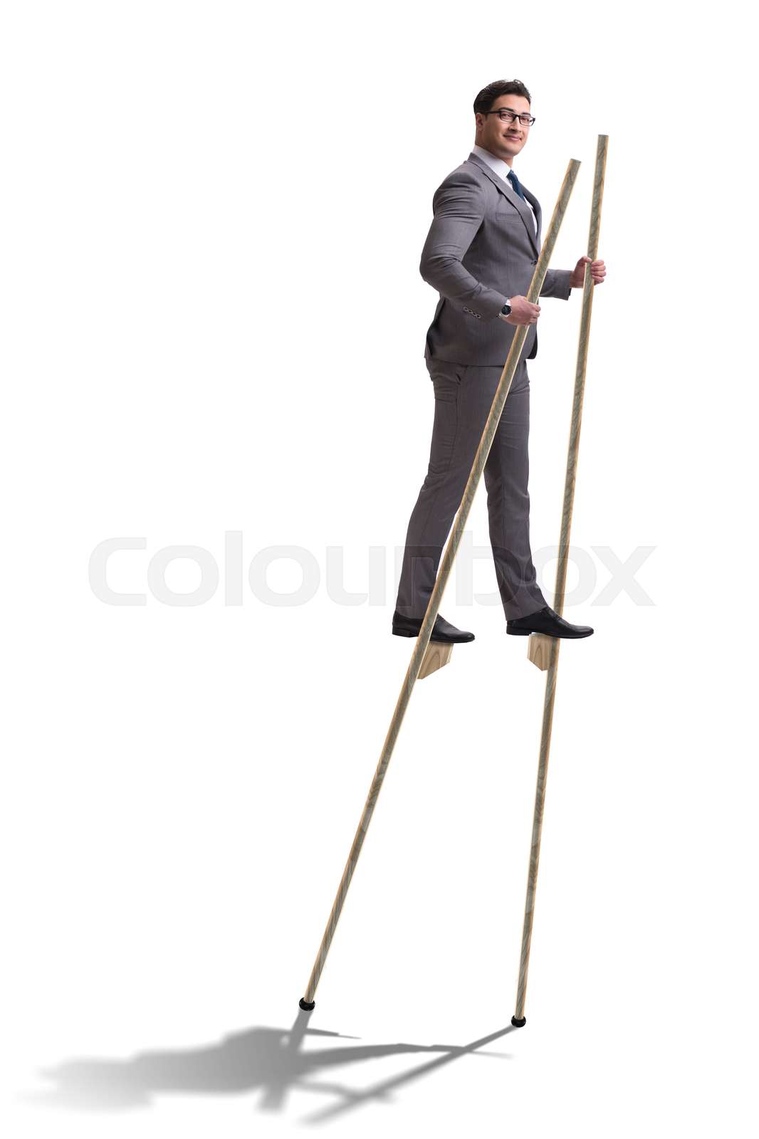 Businessman walking on stilts - standing out from the crowd | Stock ...