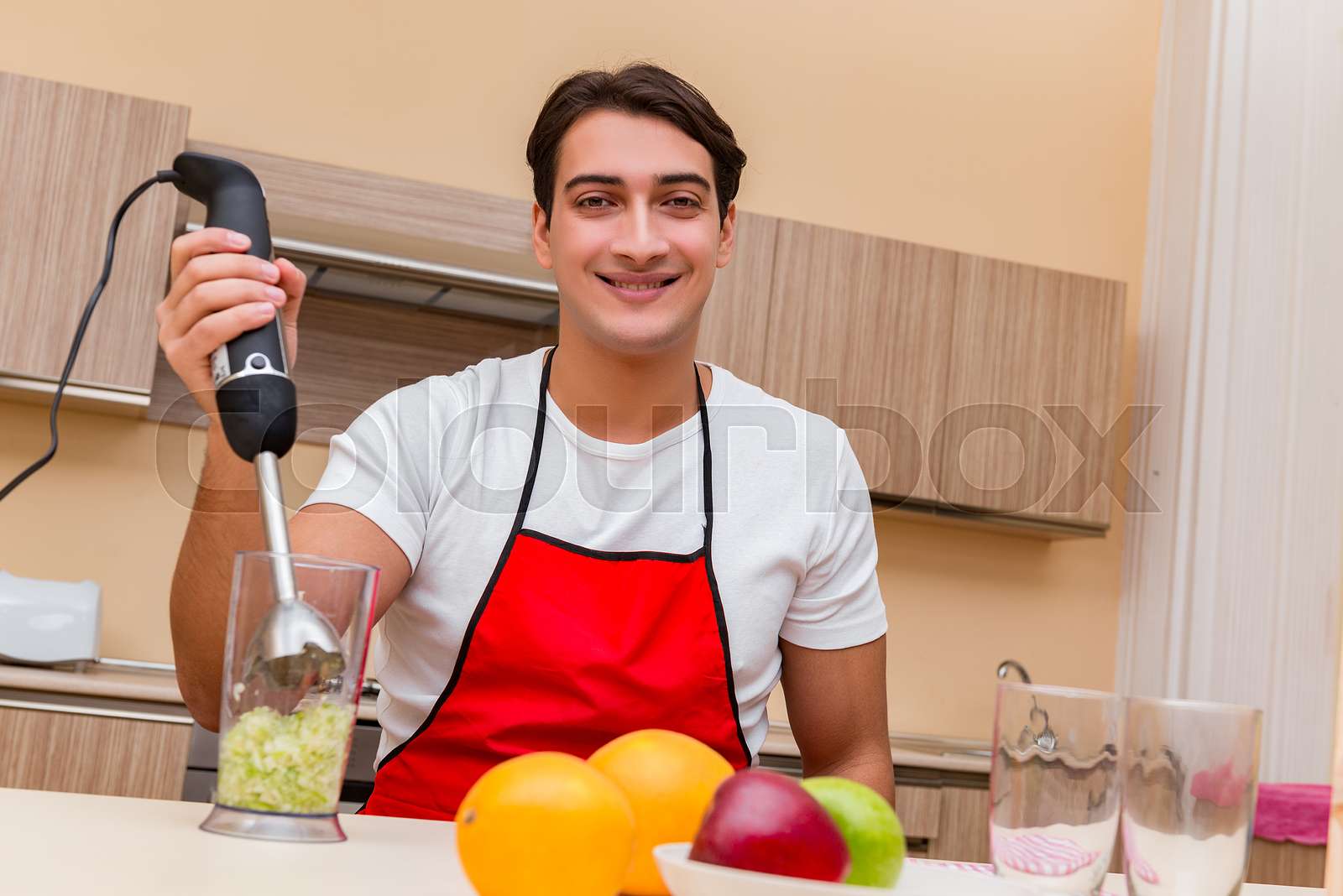 Handsome man working at the kitchen | Stock image | Colourbox