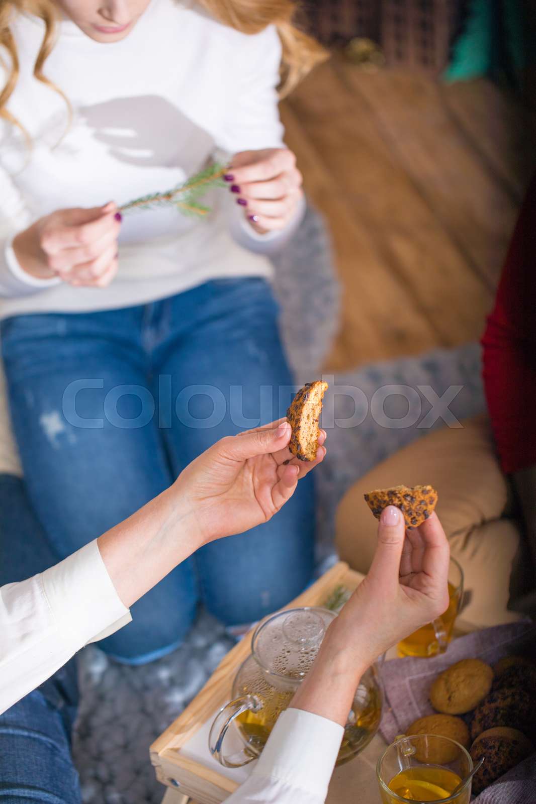 Woman breaking cookie | Stock image | Colourbox