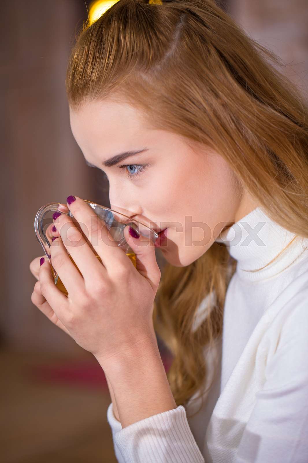 Girl holding cup of tea | Stock image | Colourbox