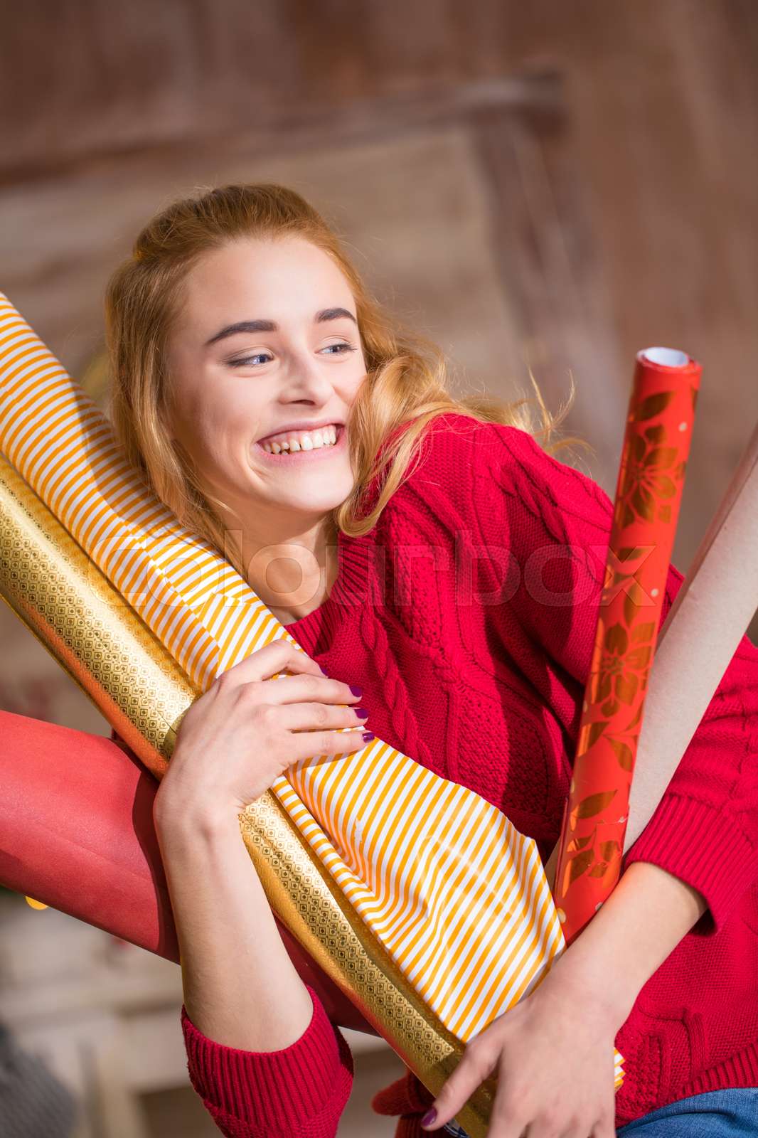 Woman holding rolls of wrapping paper | Stock image | Colourbox