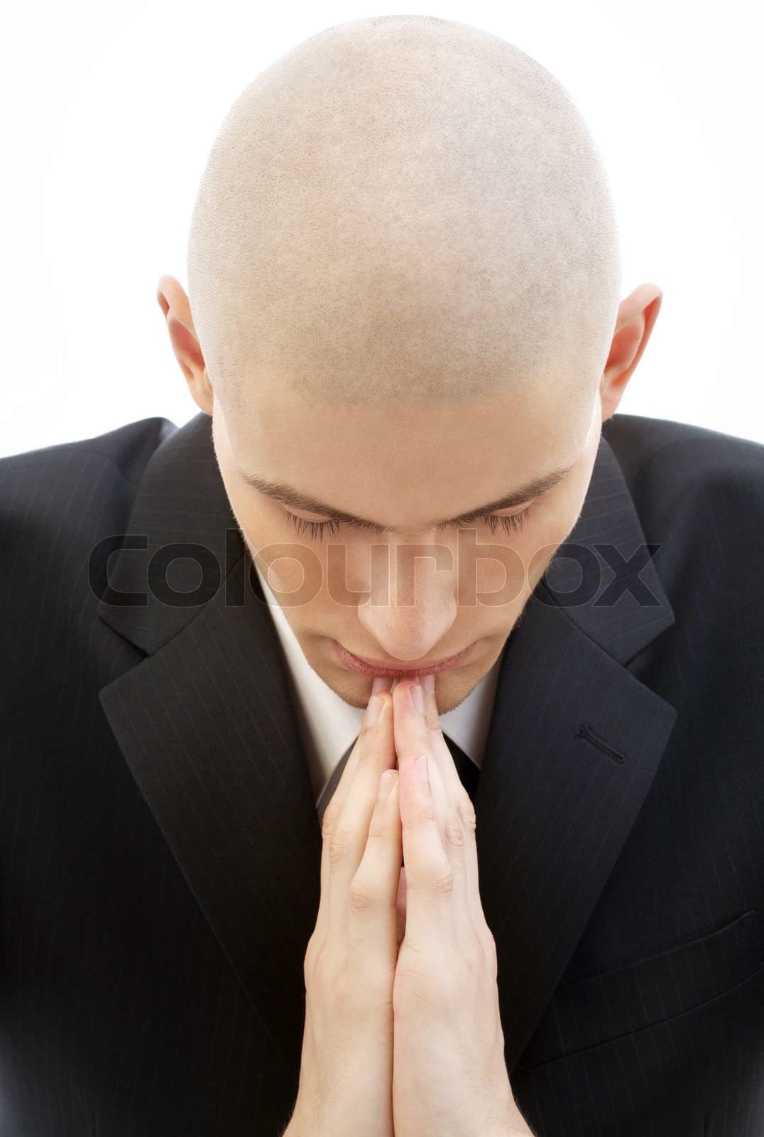 portrait of praying man in black suit over white | Stock image | Colourbox