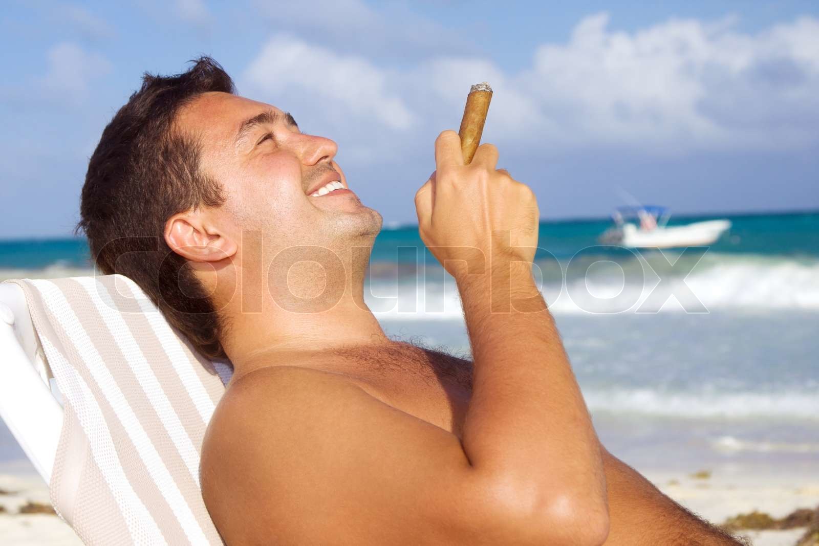 picture of relaxed man with cigar on the beach | Stock image | Colourbox
