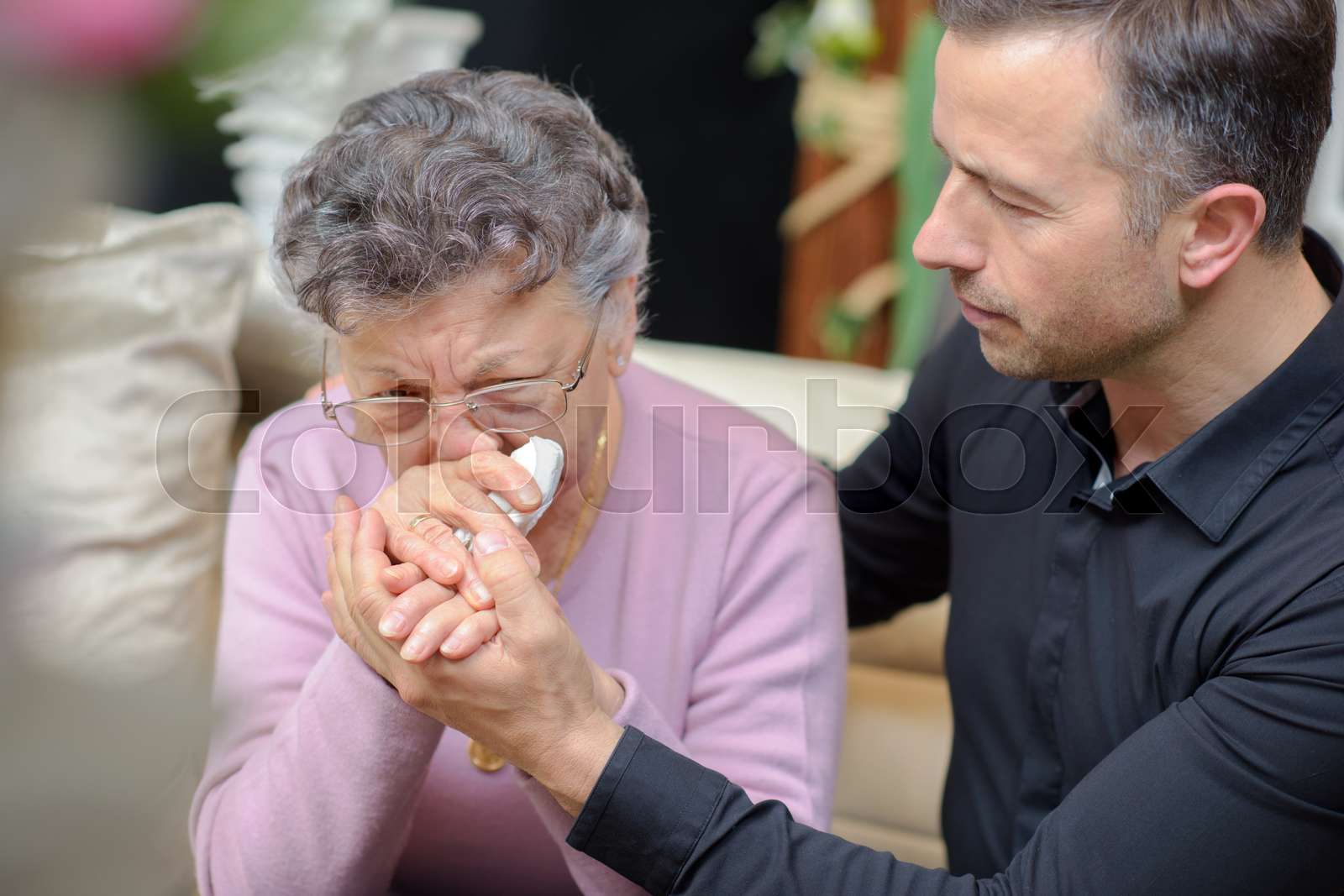 Man comforting weeping elderly lady | Stock image | Colourbox
