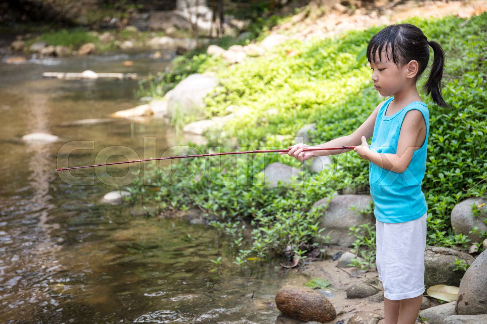 Asian Chinese little girl angling with fishing rod | Stock image ...