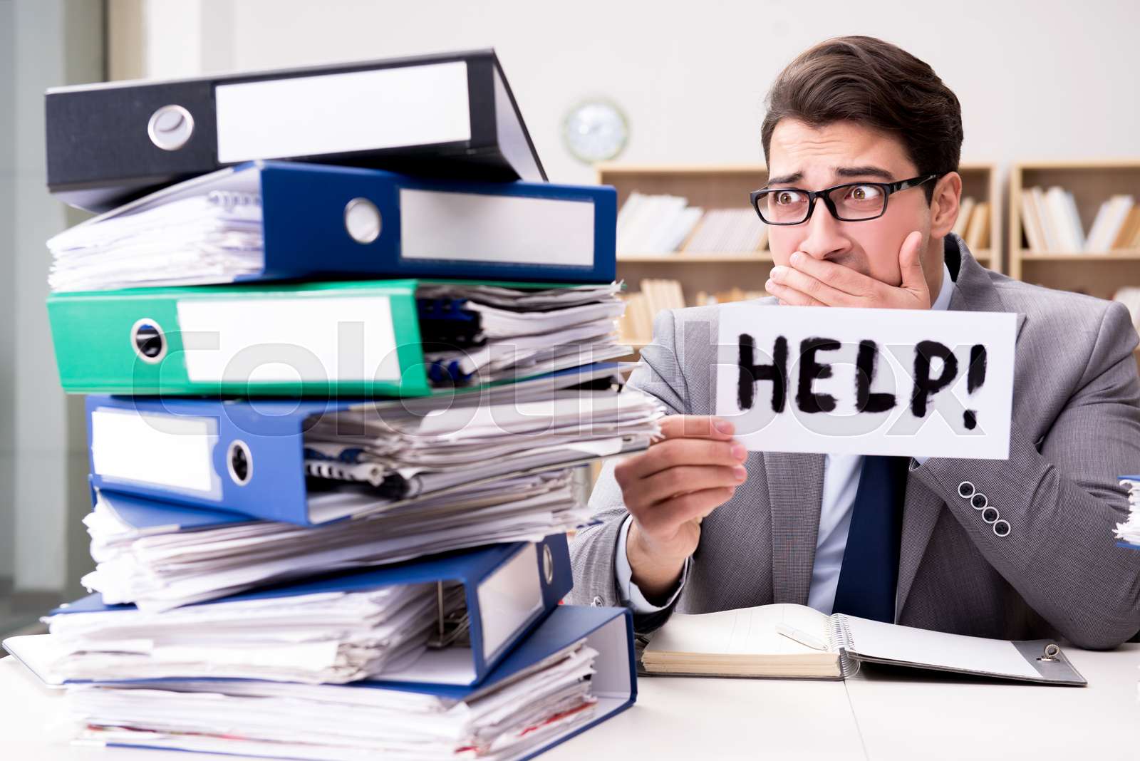 Busy businessman asking for help with work | Stock image | Colourbox