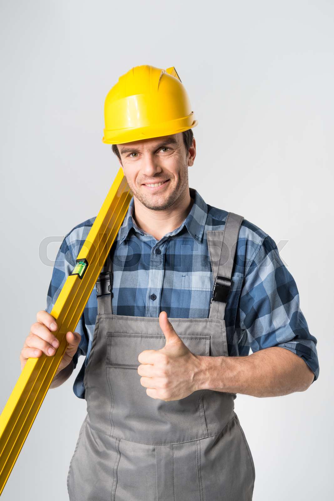 Workman with level tool | Stock image | Colourbox