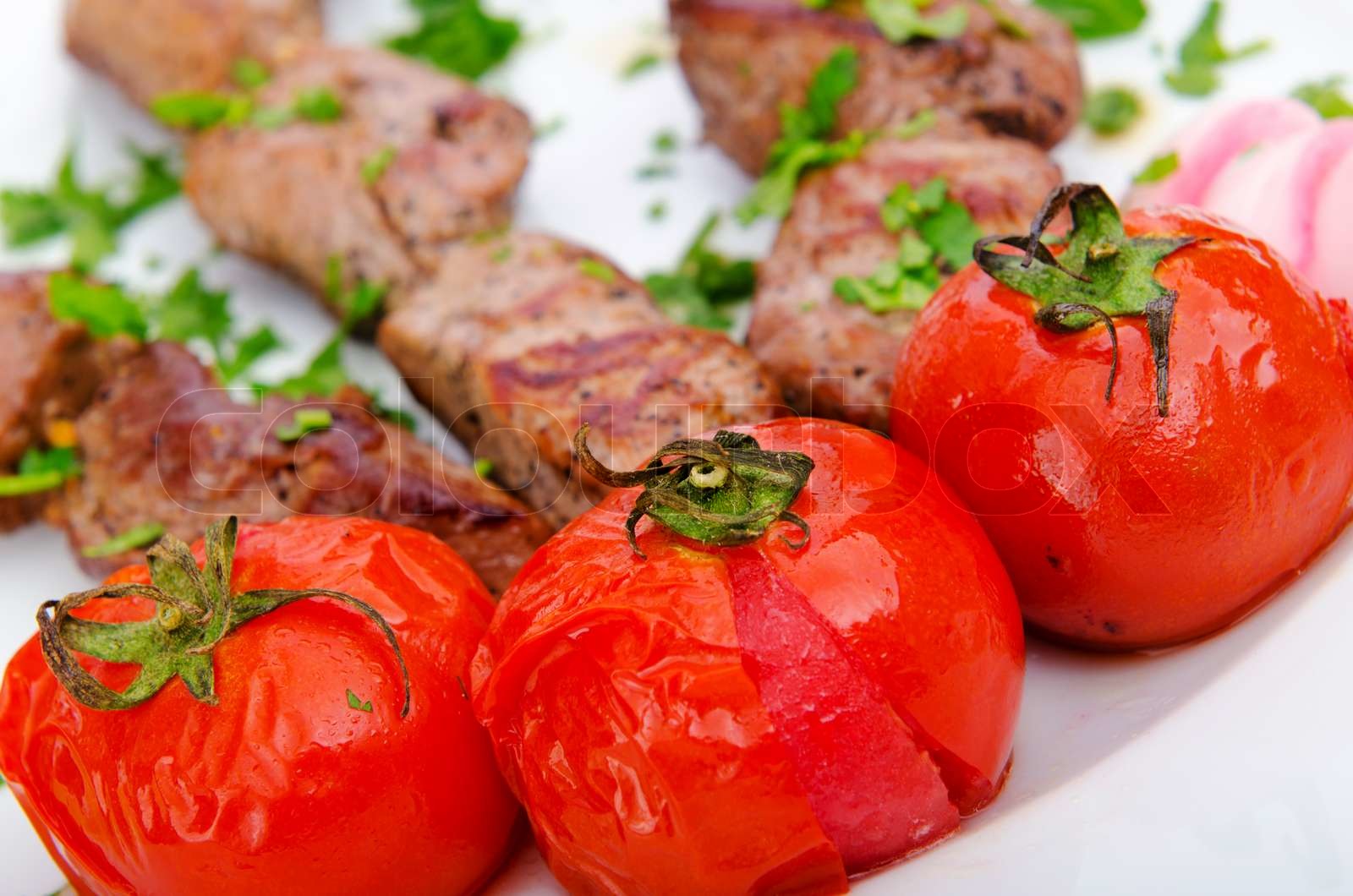 Kebab and tomatoes in the plate | Stock image | Colourbox